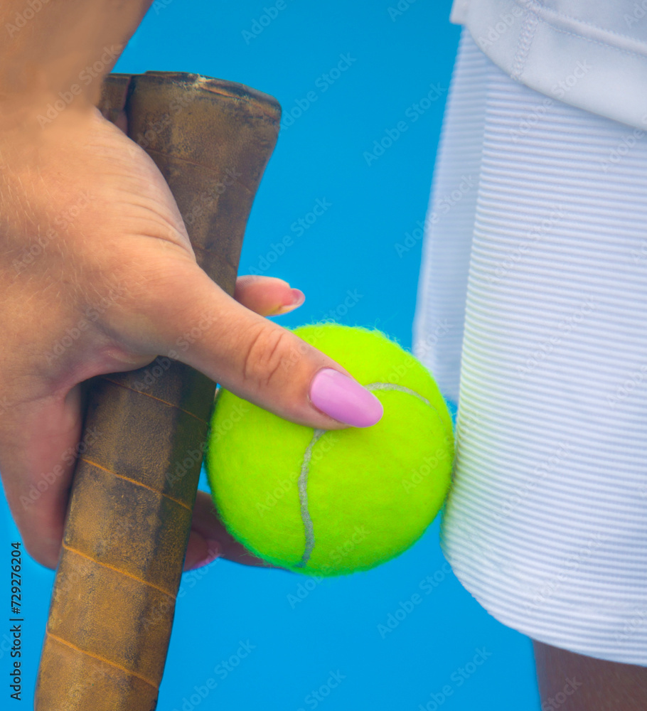 close-up of the hands of a female tennis player holding a tennis racket ...