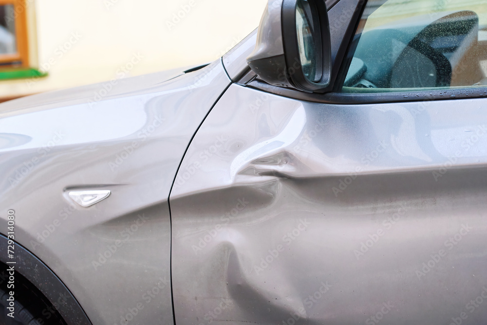 Close up of car door with large dent damage after road collision. Car ...