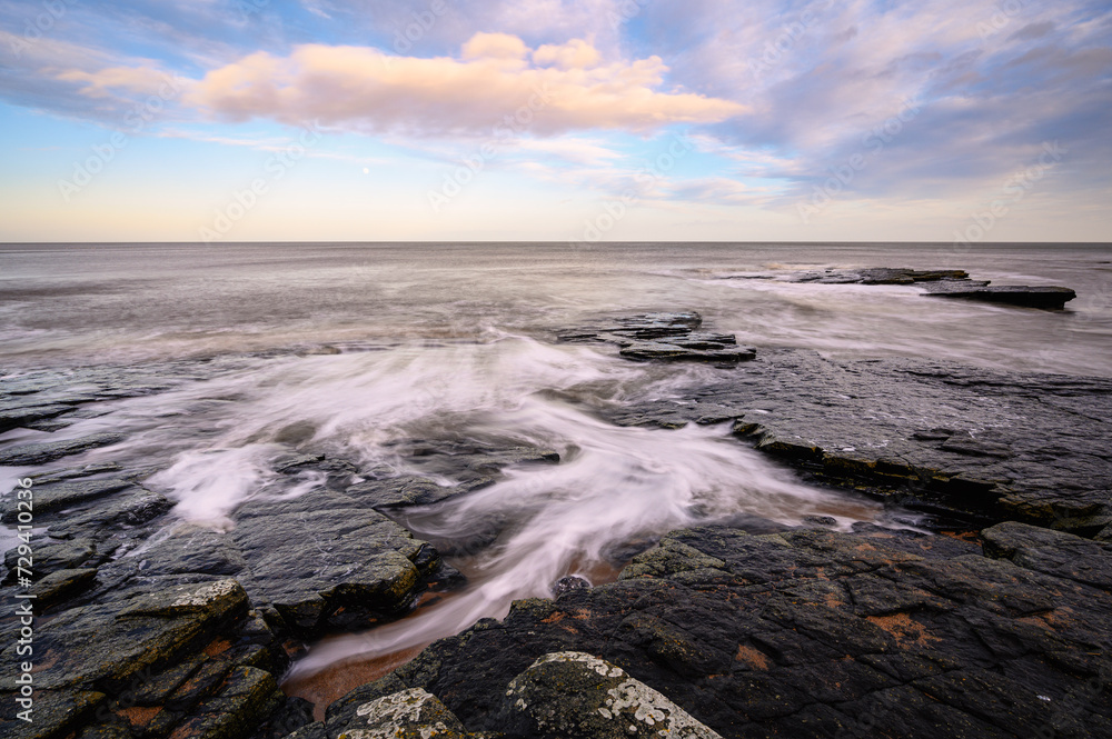 North Sea twists through Howick Rocks, on the rocky shoreline at Howick ...