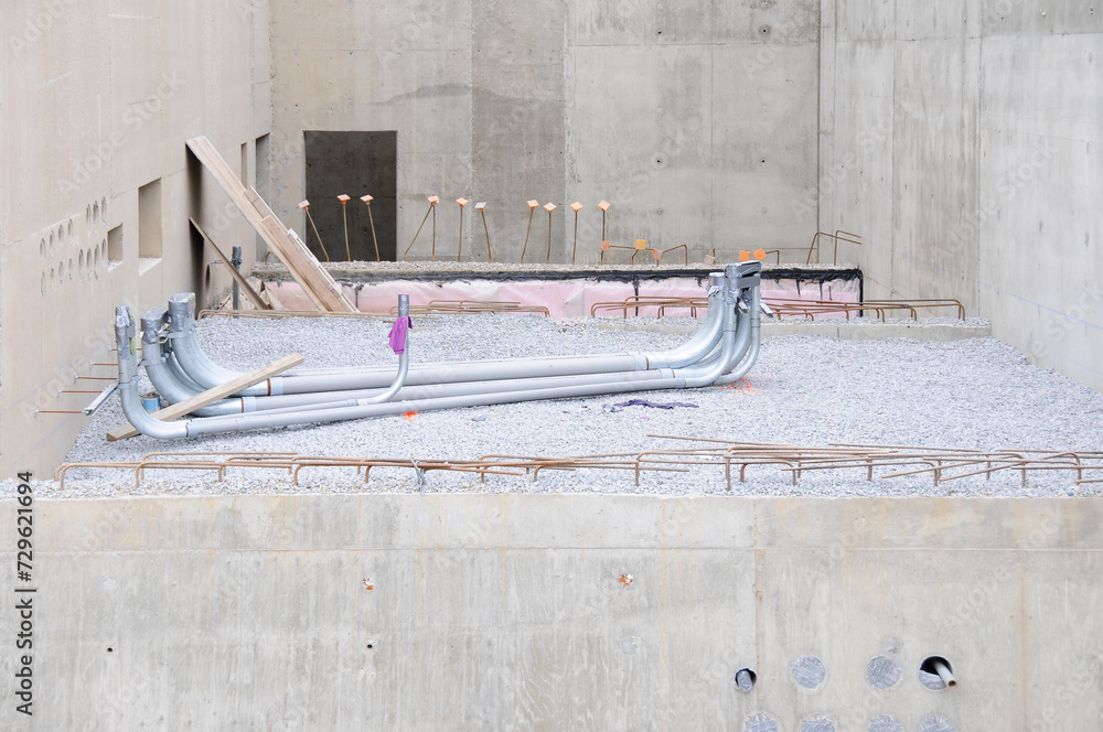 Conduits placed on gravel and ready for concrete slab installation on a ...