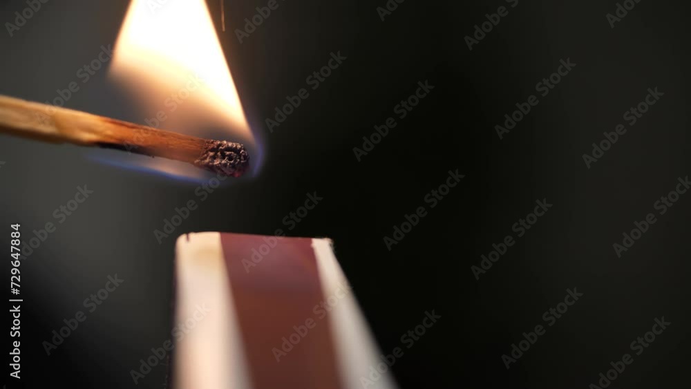 Vidéo Stock Strikes a match on the side of the box. Smoke and fire ...