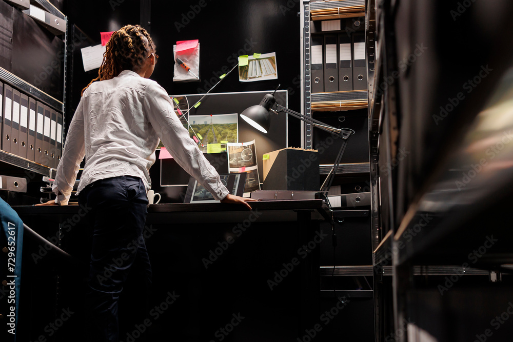 African american woman private detective looking at surveillance photos ... African american woman private detective looking at surveillance photos ...