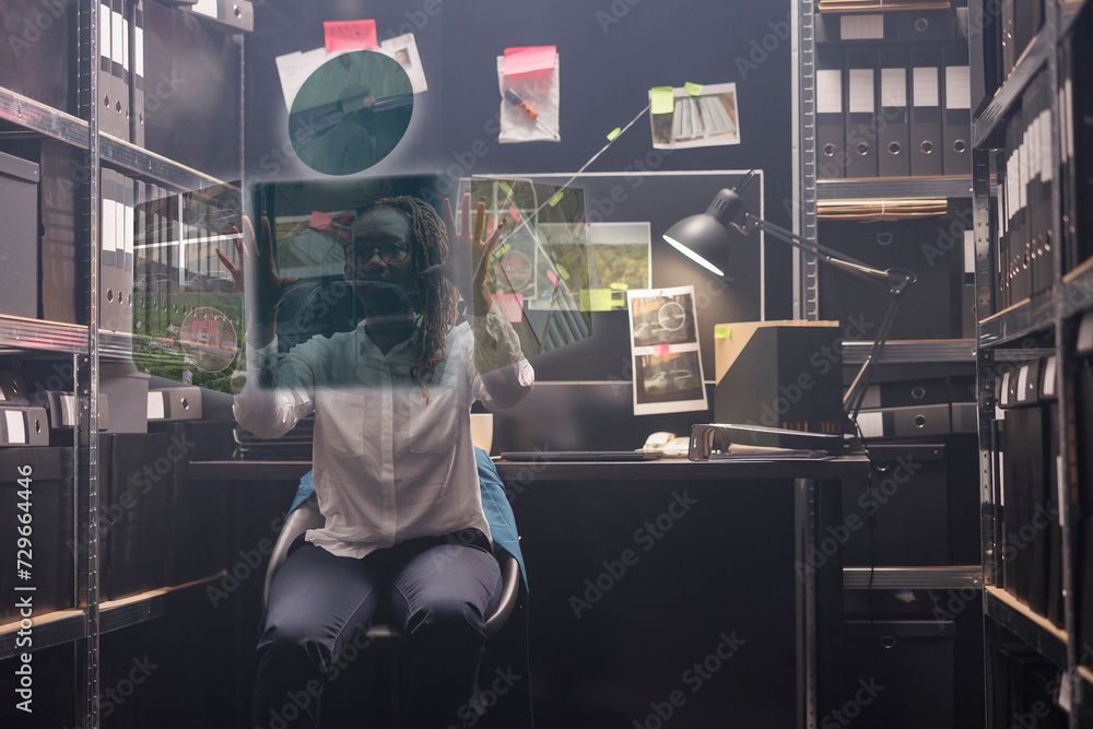 Young policewoman looking at clues in hologram, examining augmented ...
