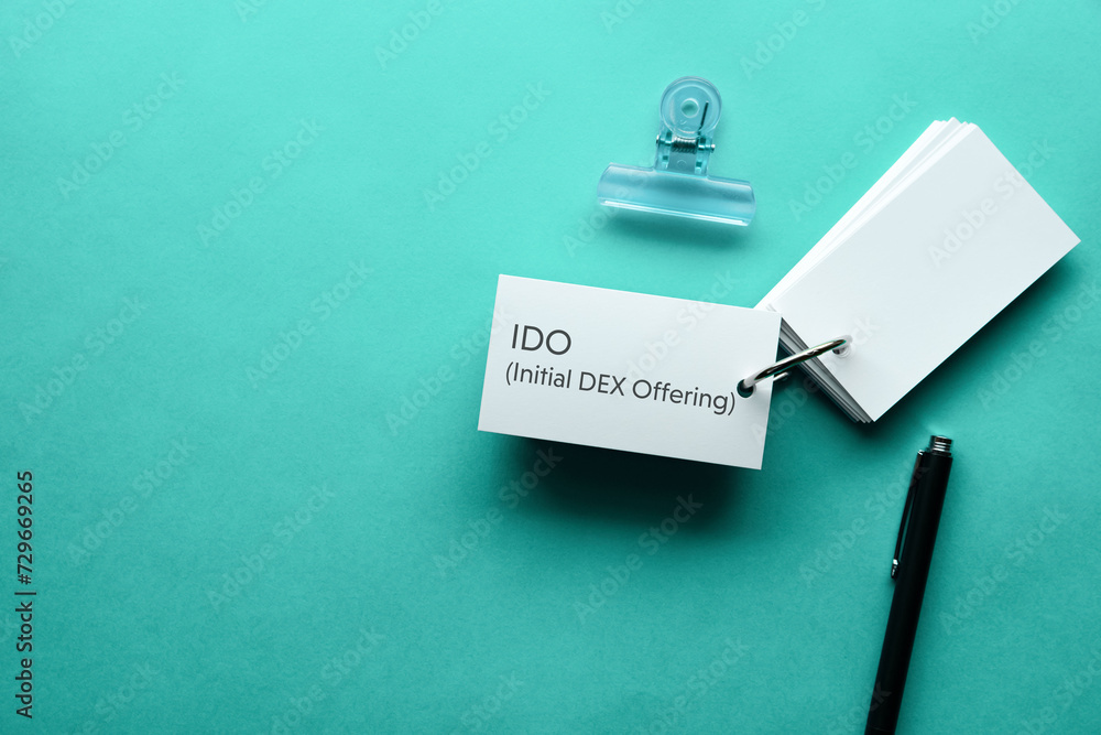 There is wood cube with the word IDO (Initial DEX Offering). It is as ...