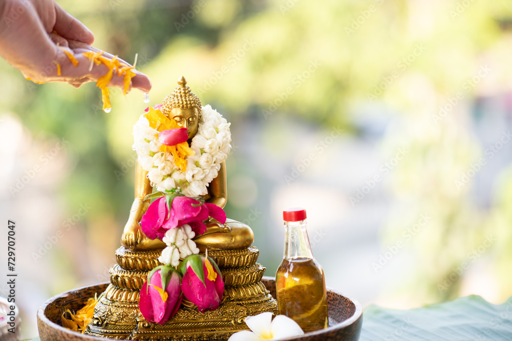 Sprinkle water onto buddha with water with flowers , thai traditional ...