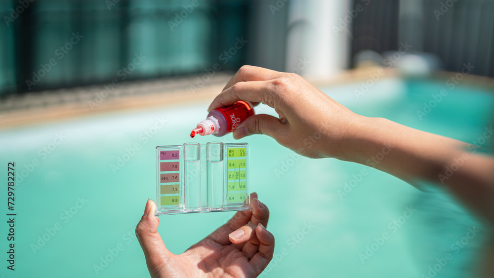 Action of a person hand is using Phenol red droplet to drop into sample ...