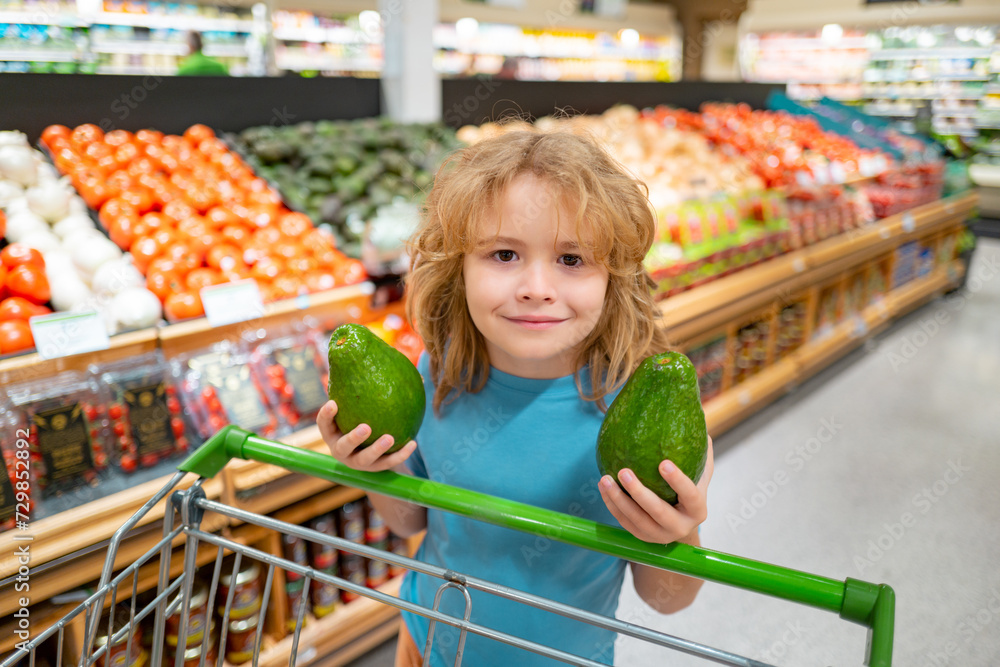 Happy little kid with fruits and vegetables at grocery store. Healthy ...