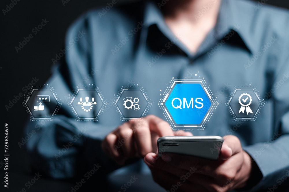 QMS, Quality management system concept. Businessman use smartphone with ...