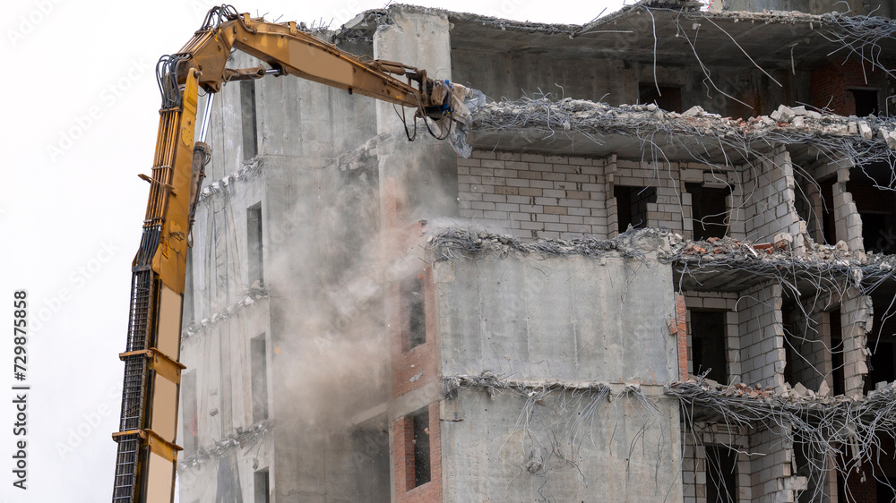 Large hydraulic crane dismantling building, demolition of long-term ...