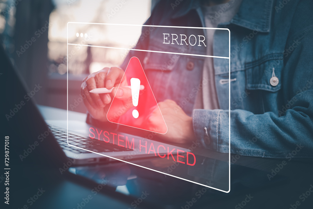 programmer using laptop with triangle caution warning sign for ...