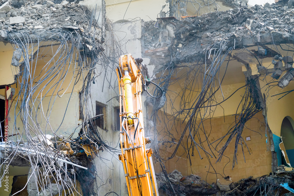 An special excavator destroys an old concrete house. Lots of twisted ...