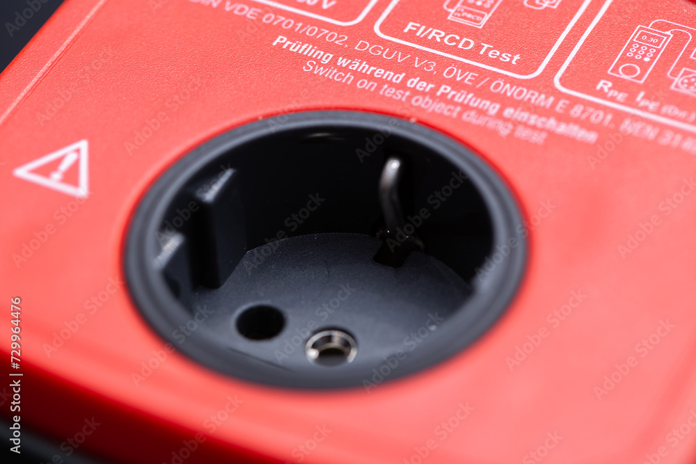 closeup of the power plug of a tester device to measure and prove the ...