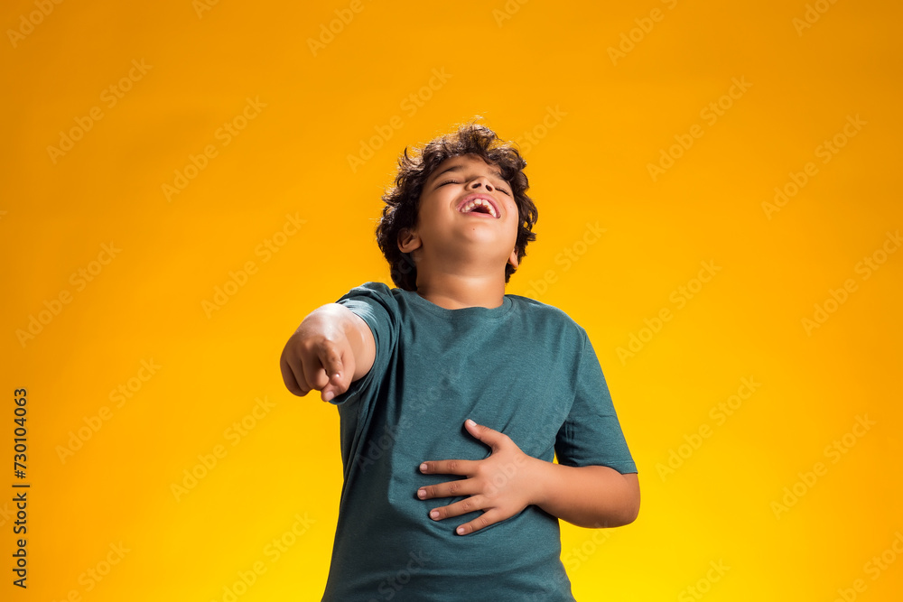 Kid boy mocking and teasing at someone showing finger at camera and ...