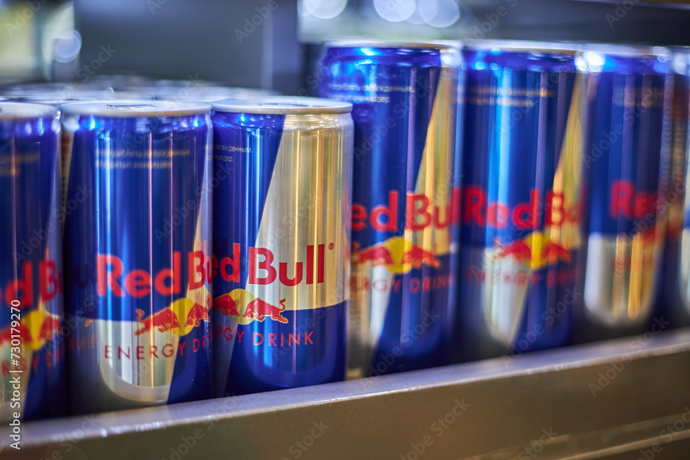 Aluminum cans of Red Bull soda energy drink of different sizes and ...