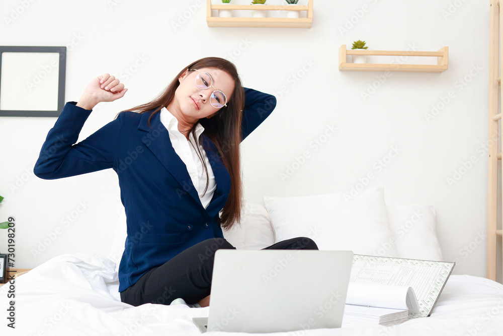 Female office worker wearing a suit has body aches. She was sitting on ...