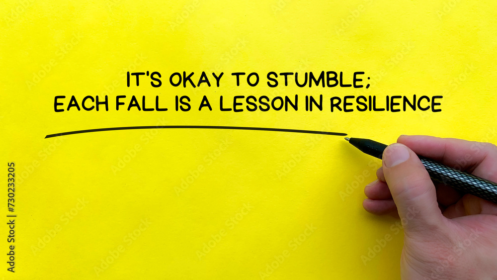 Hand writing It is okay to stumble affirmation on yellow cover ...