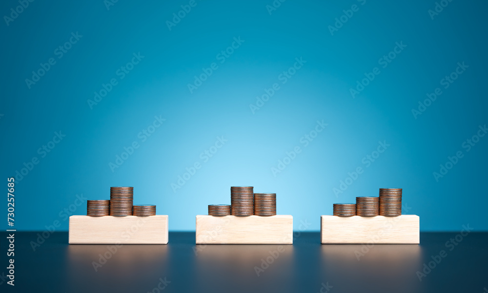Stack of coins on blank wooden blocks for your words with blue ...