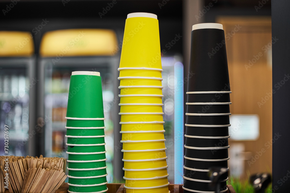 Blank three stacks of colored paper cups, green yellow black cup ...