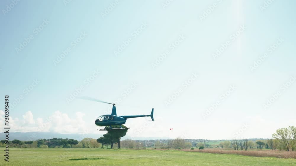 Private helicopter with rotating blades hovering in air above the ...