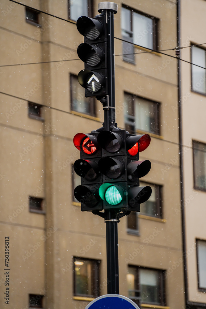 Traffic lights with direction arrows on the lights showing directions ...