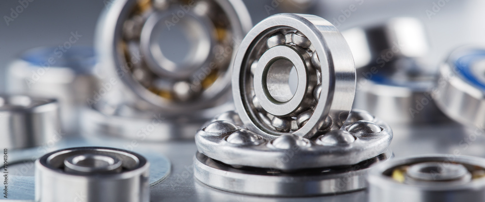 Poster different bearings on a metal background. Part of mechanism ...