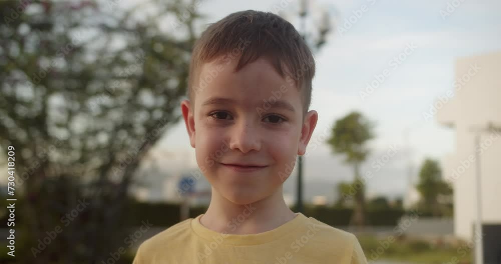 Cute child shows thumbs up gesture, happy facial expression emotion ...