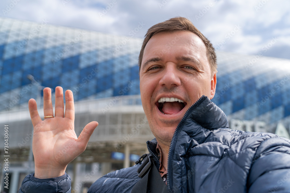 Happy mature man is pulling a funny face by contorting his hand in a ...