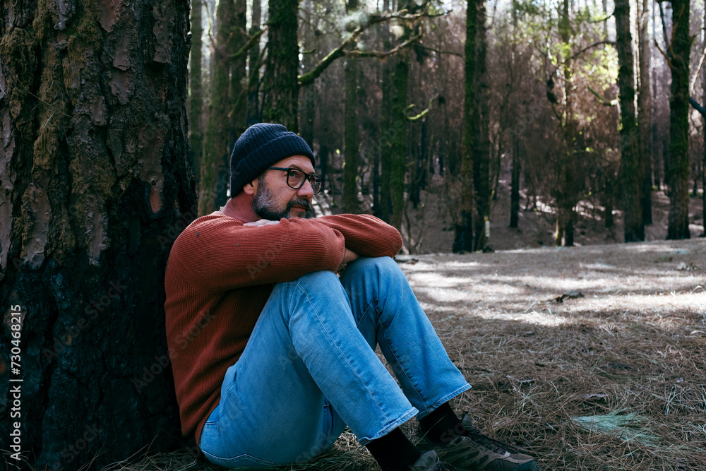 One man having relaxation time sitting on the ground in the middle of ...