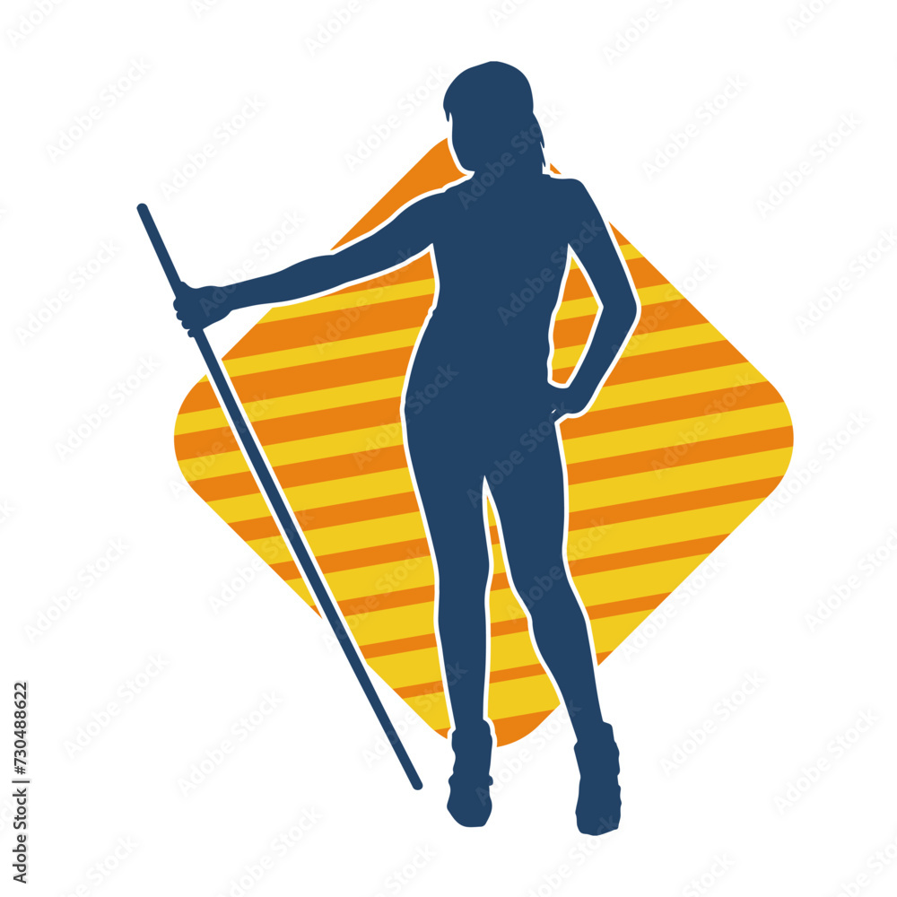Silhouette of a slim female fighter in standing pose with her staff ...