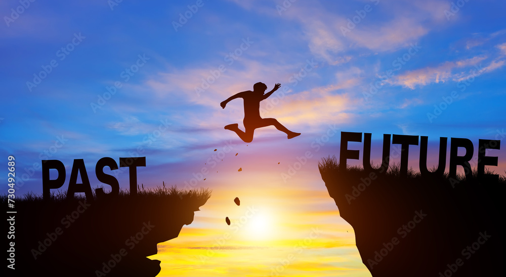 Silhouette man jumping from PAST to FUTURE wording on cliffs with cloud ...