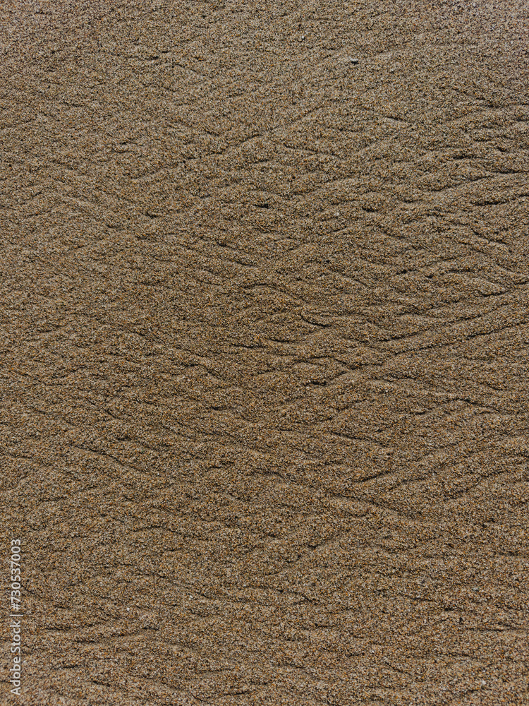 Texture of the sand on a beach in San Francisco after the tide pulls ...