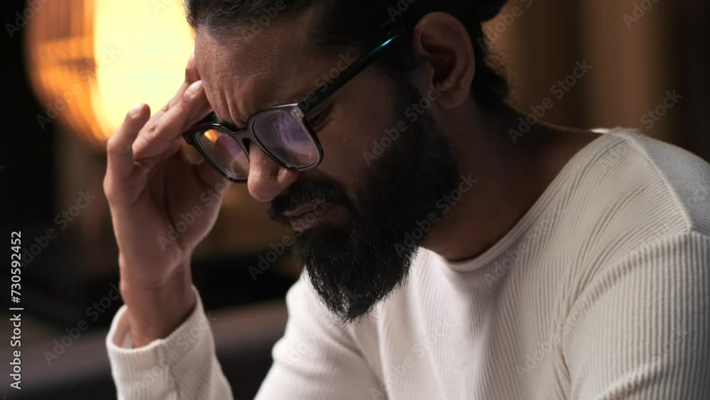 Sad and stressed Indian man with a headache, depression, exhaustion ...