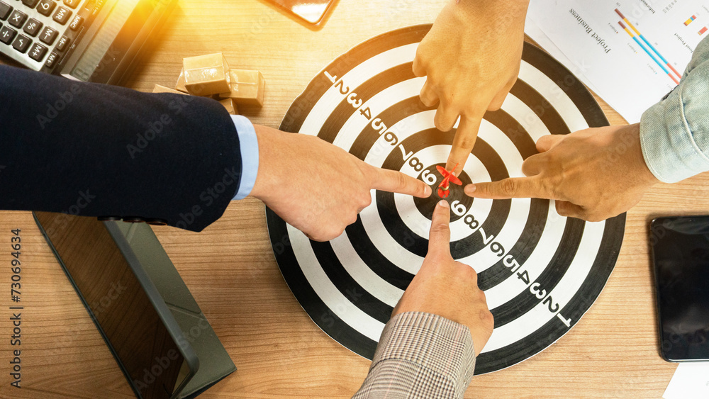 Businessman Point to a darts aiming at the target center business ...