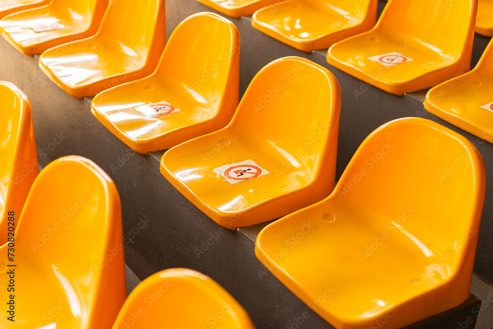 Plenty of yellow plastic seats at stadium. Bright yellow seats for fans ...