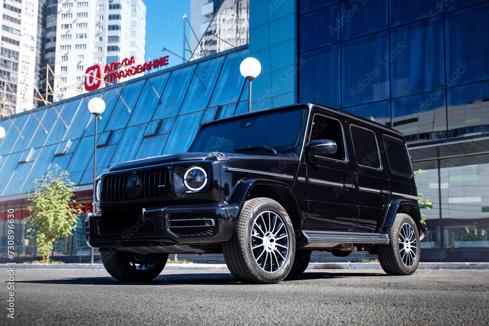 car on the street of the town Mercedes-Benz G-Class black logo detail ...