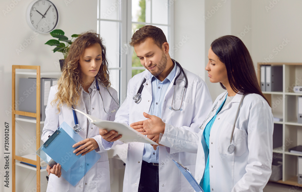 In the hospital office, a dedicated team of doctors and nurses engages ...