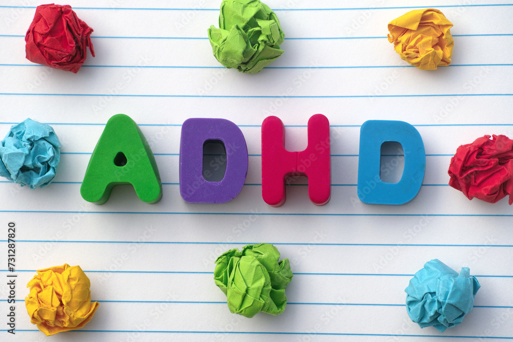 ADHD. The abbreviation ADHD on a notebook sheet with some colorful ...