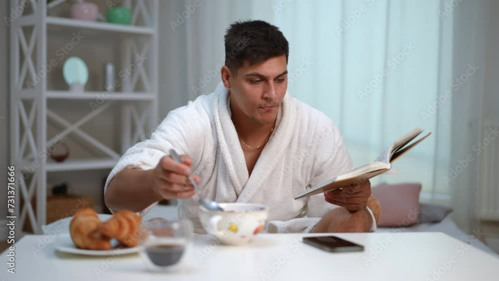 Slow motion. The young man was so engrossed in reading a book during ...