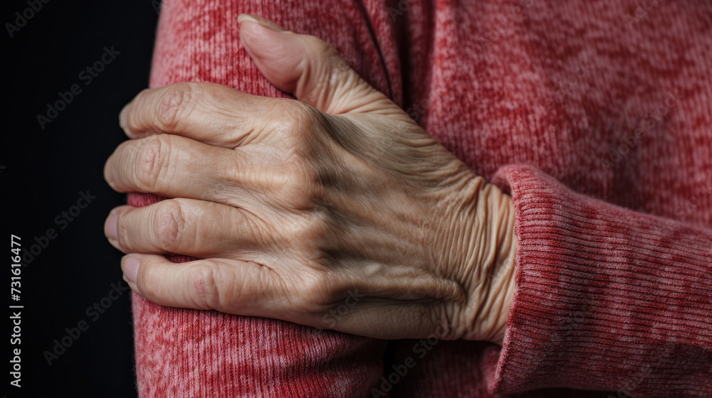 gnarled wrinkled skin of hands and fingers holding on the shoulders of ...