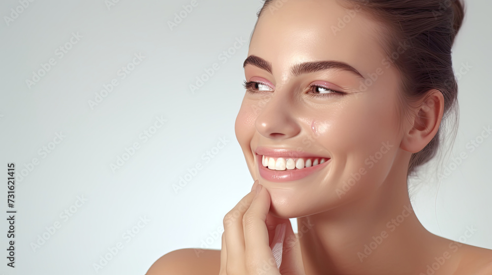 Beautiful smiling woman with glowing skin taking skin care products on ...