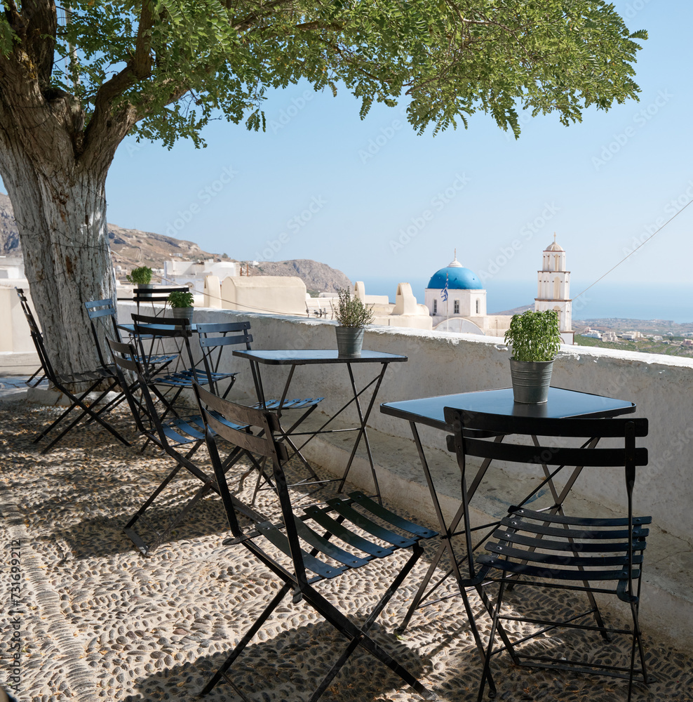Greek blue chairs and tables on a typical sunny terrace with a lovely ...