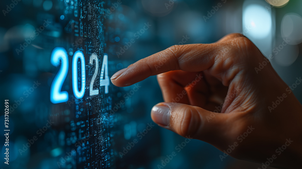 Hand pressing 2024 button on a futuristic touch screen with binary code ...