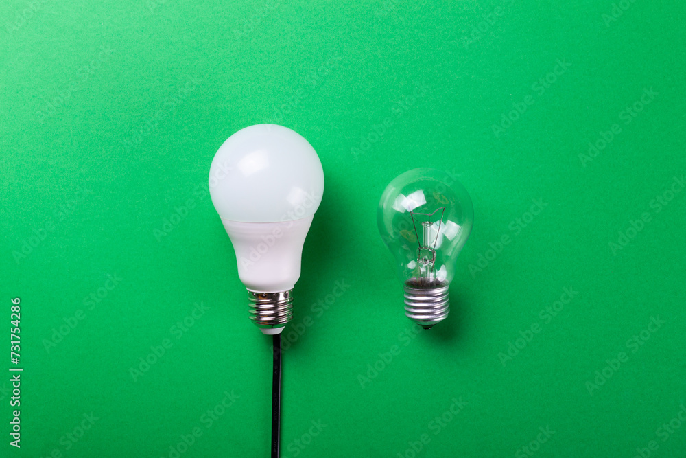 incandescent lamp and led lamp against on isolated green background ...