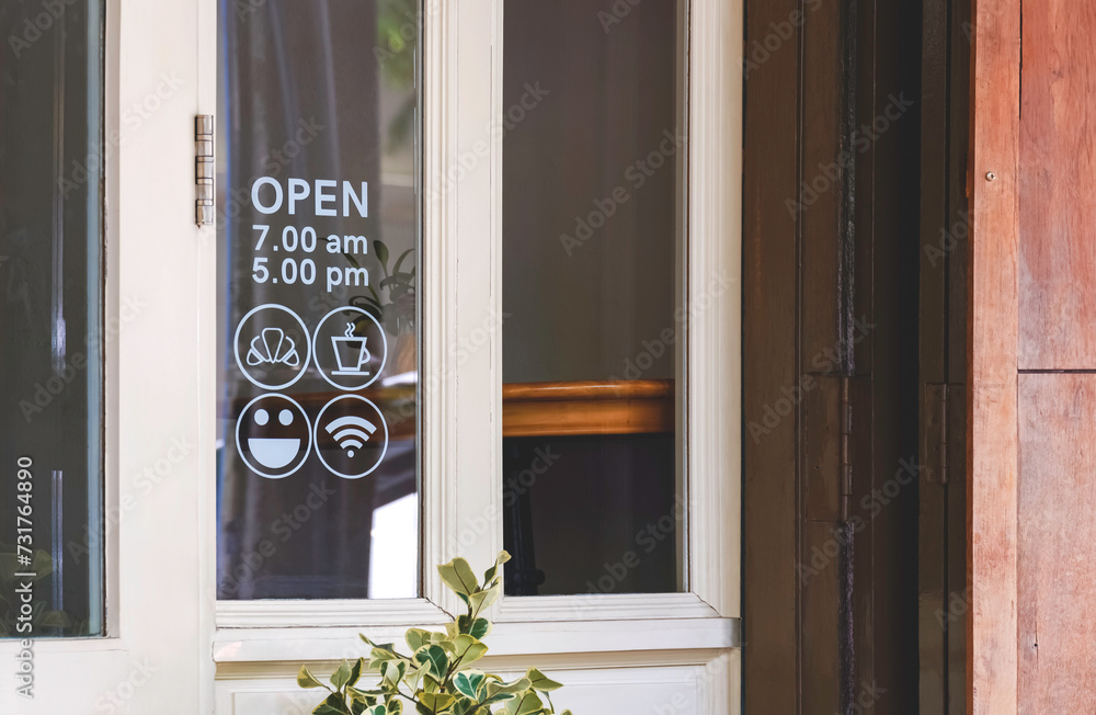 Information service icon signs on glass window with white wooden ...