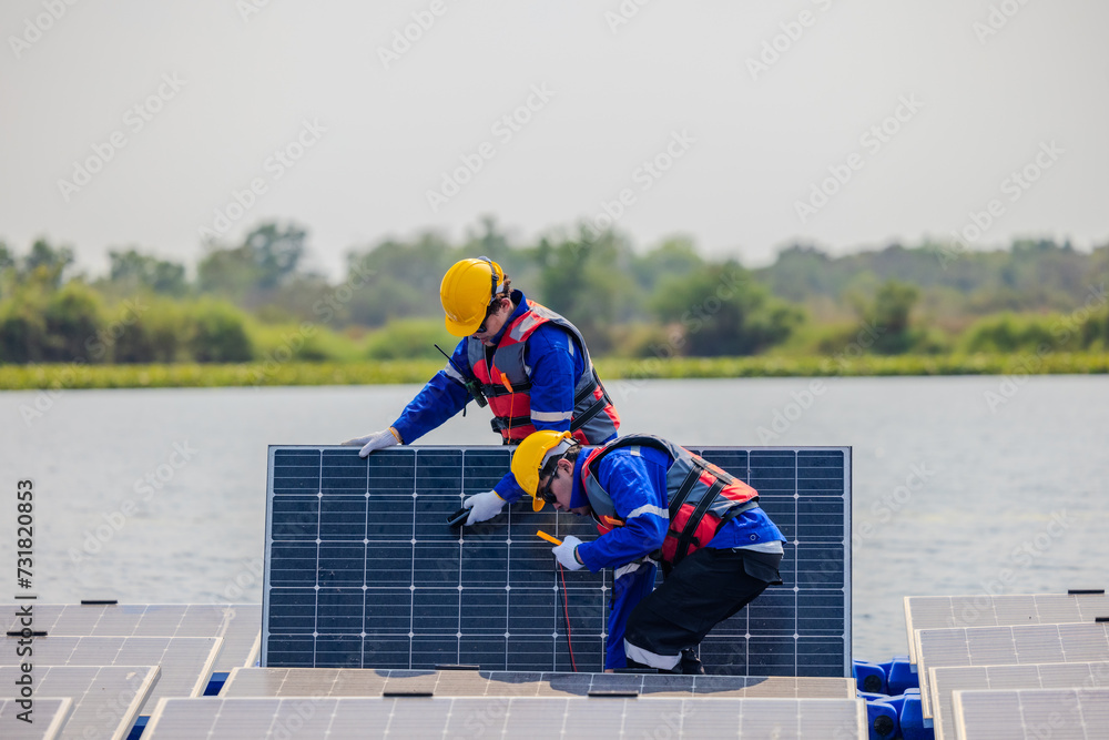 Technicians check floating solar farm wiring, polarity, and grounding ...