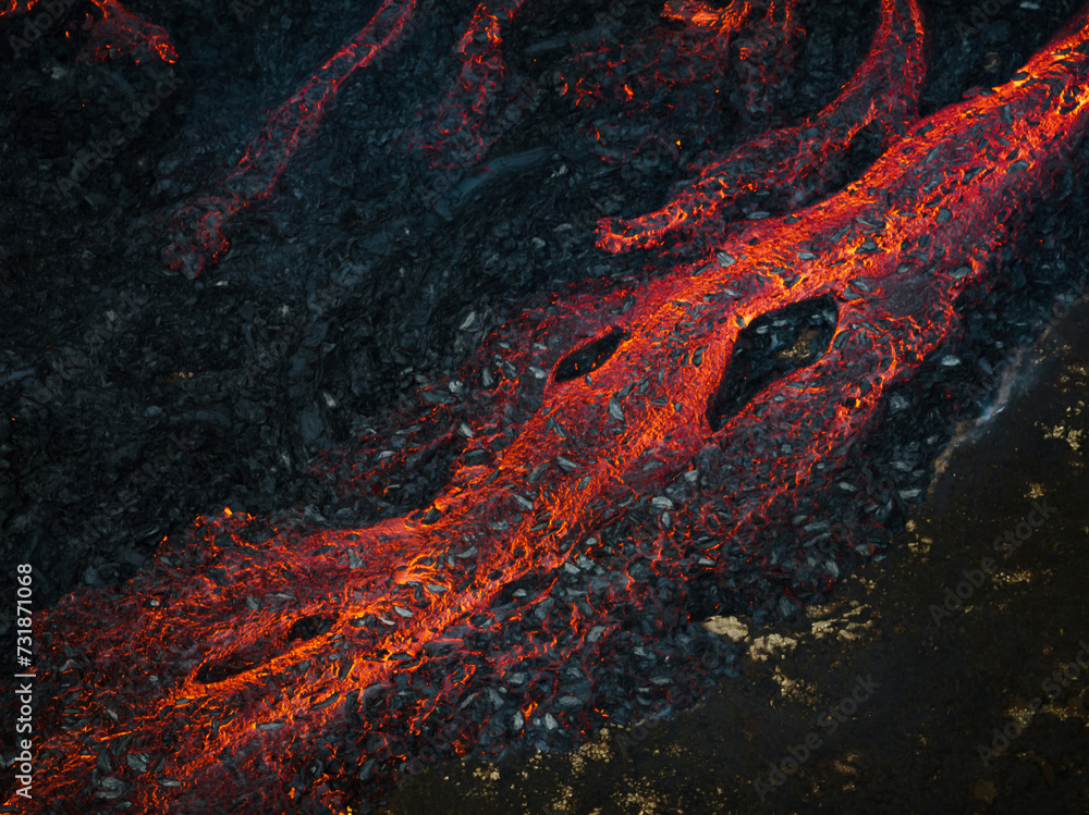 Streams of red hot lava flowing during a volcano eruption, toxic smoke ...
