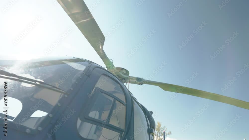 Bottom view shot of private helicopter on airfield against sunshine ...