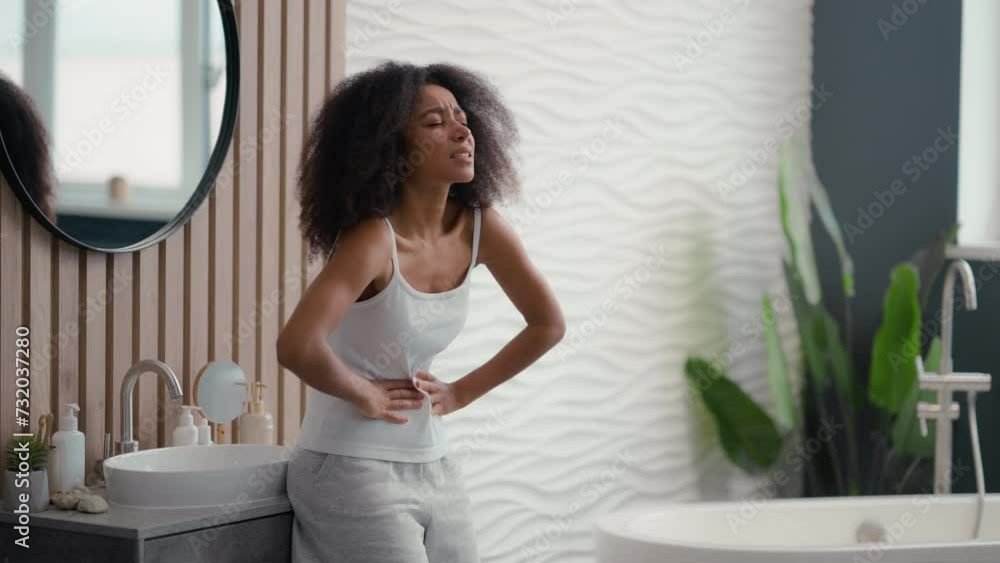 African American ill sick unwell sad woman with stomach ache standing ...