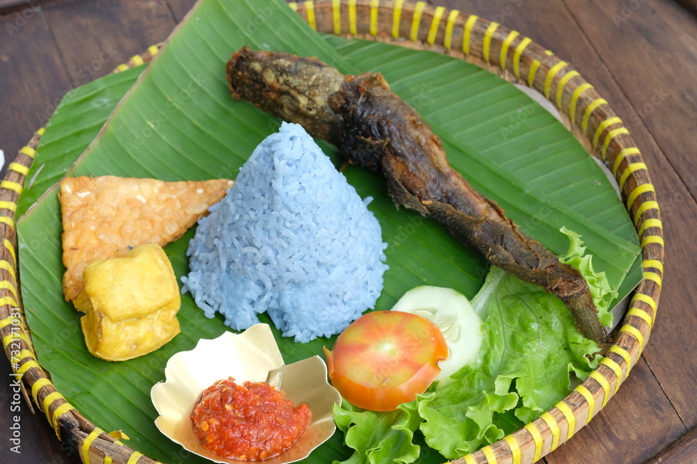 Tumpeng Pecel Lele Tahu Tempe is Cone-shaped rice, dyed with natural ...