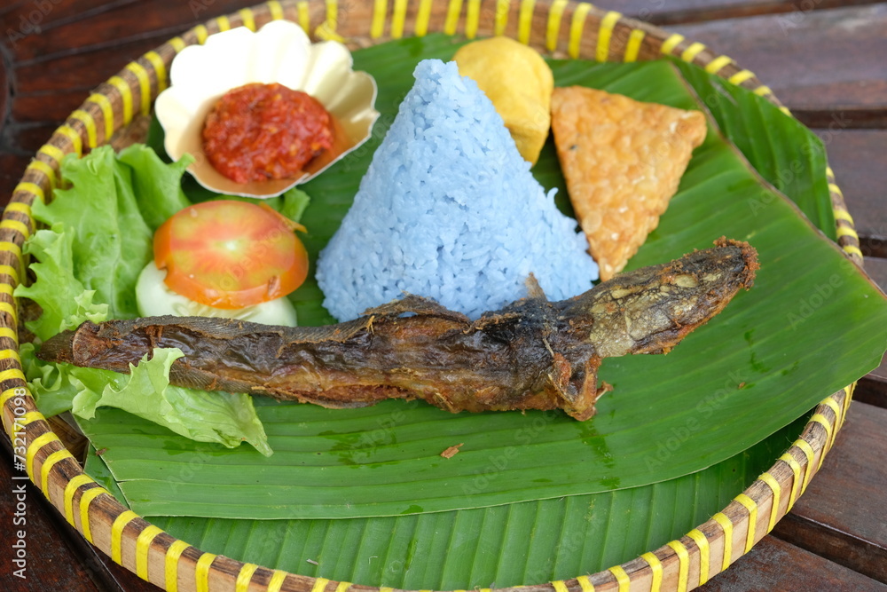 Tumpeng Pecel Lele Tahu Tempe is Cone-shaped rice, dyed with natural ...